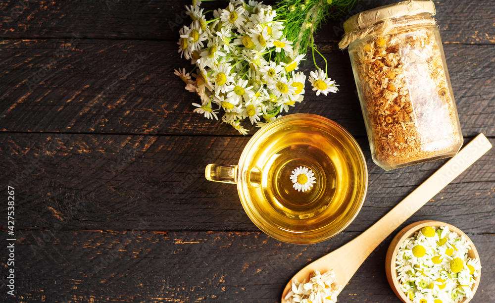 cup of herbal chamomile tea with fresh daisy flowers background ...