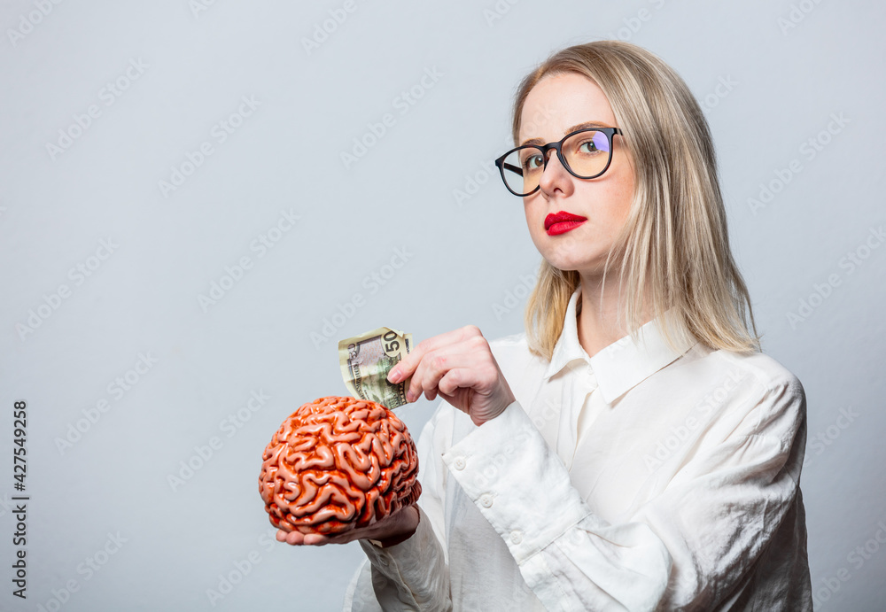 Portrait of beautiful blonde in white shirt with human brain on white ...