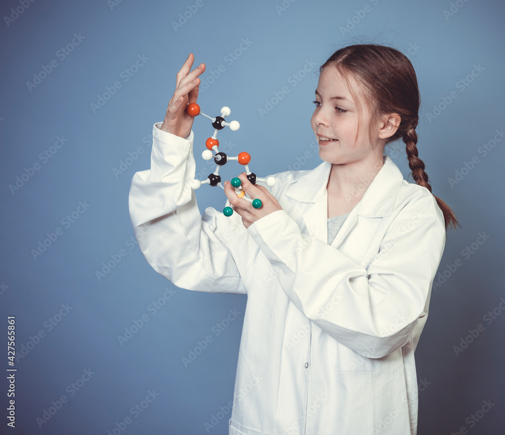 pretty girl with two braids is dressed as scientist and holds model of ...