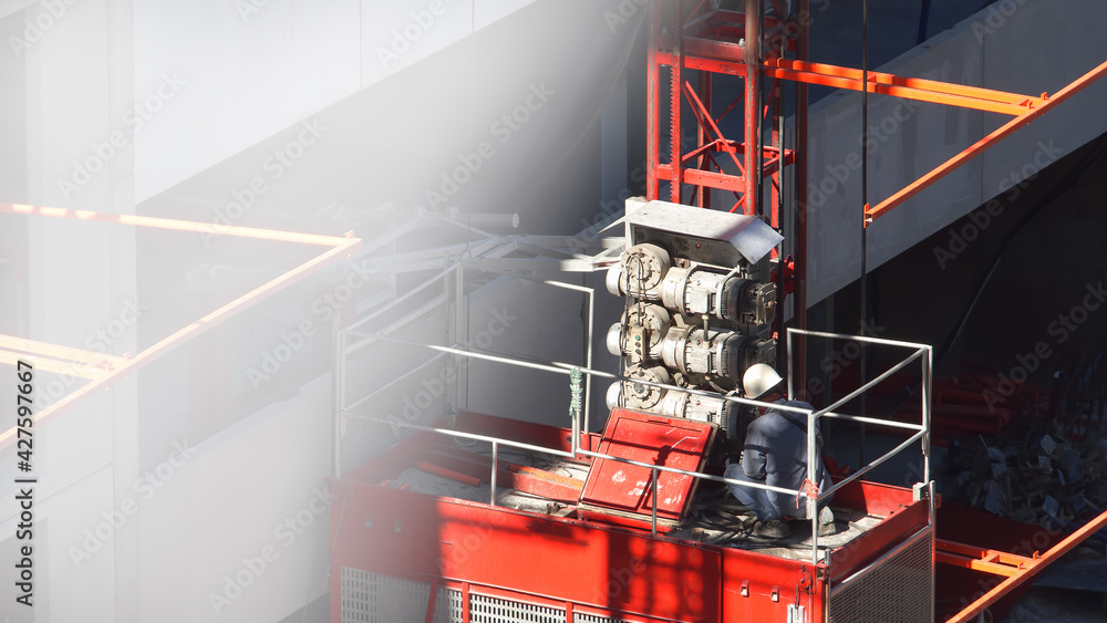 Engineer are working inspecting outdoor passenger lift system with copy ...