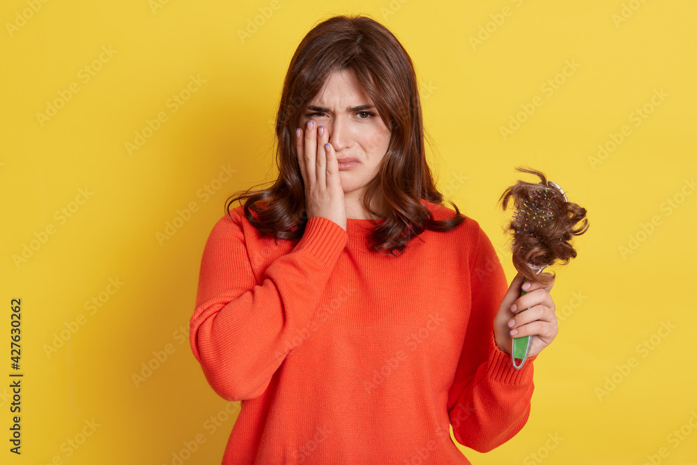 Crying woman suffering from hair loss, being frustrated, covering her ...