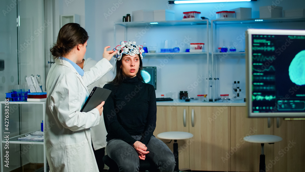 Doctor analysing brain scan using tablet, examining evolution of ...