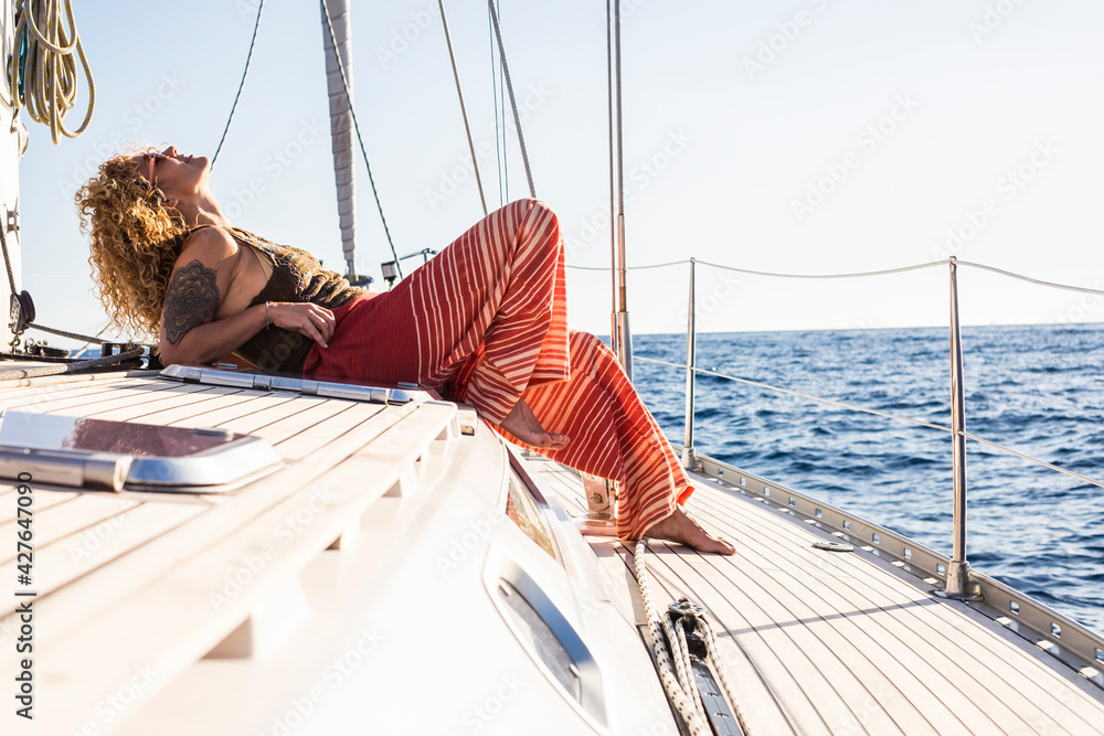 Attractive woman sailing on a yacht on summer day - relax and vacation ...