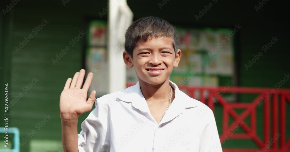 Slow motion scene of a smiling poor Asian elementary school student in ...