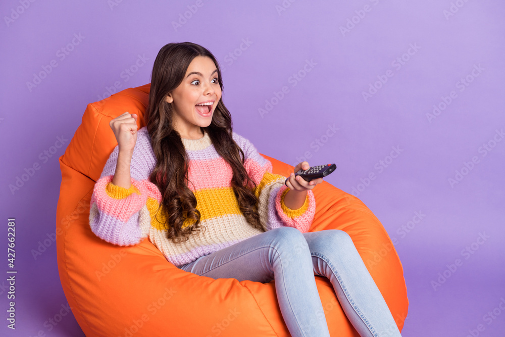 Profile side photo of young girl watch tv hold remote control rejoice ...