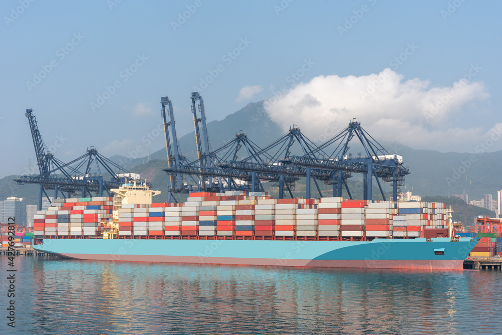 Cargo container ship berthed in port of Yantian. She is fully loaded ...
