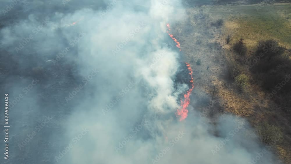 Man watching the fire. Aerial view Spring fires. Emissions of dust and ...