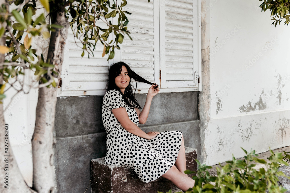 Beautiful Young Woman Sitting On Stone Bench In Front Of Old White ...