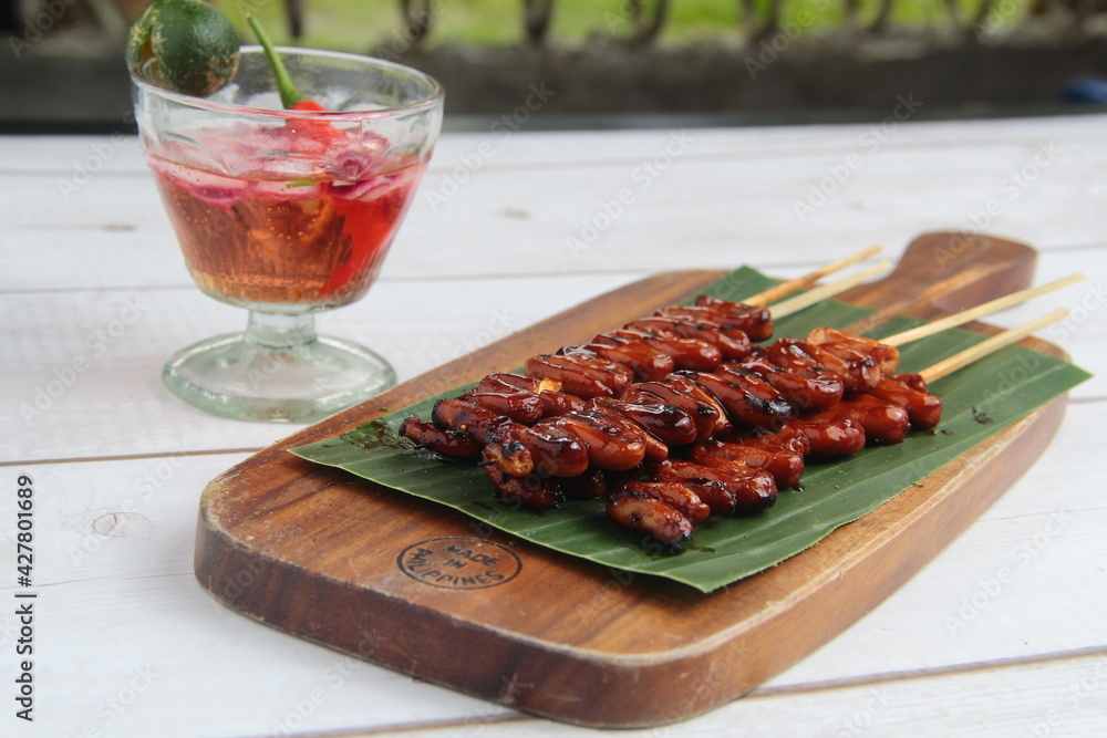 Freshly cooked Filipino food called Isaw or grilled chicken intestine ...