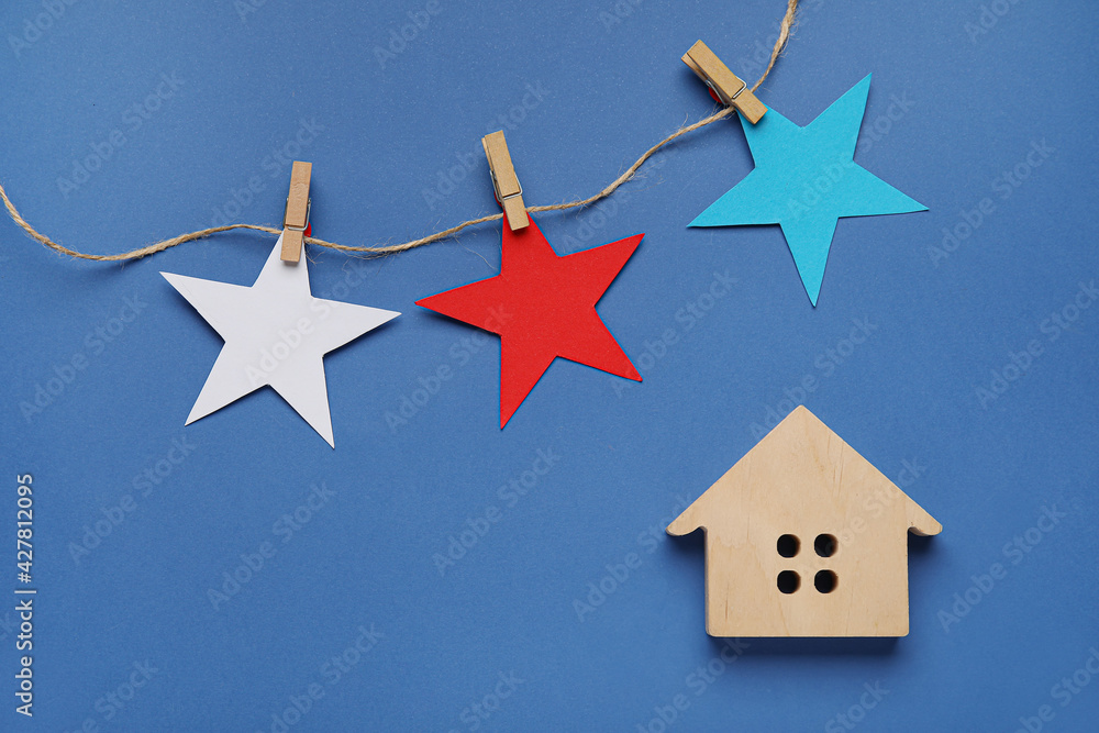 Figure of house and stars in colors of USA flag on color background ...