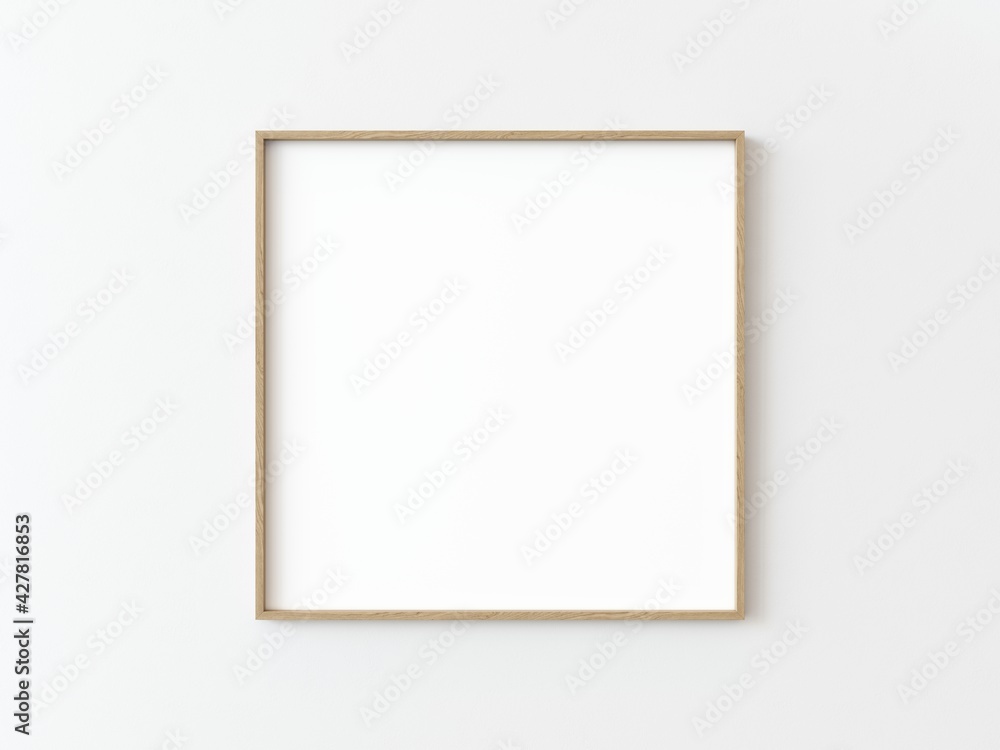 One light wood thin square frame hanging on a white textured wall ...