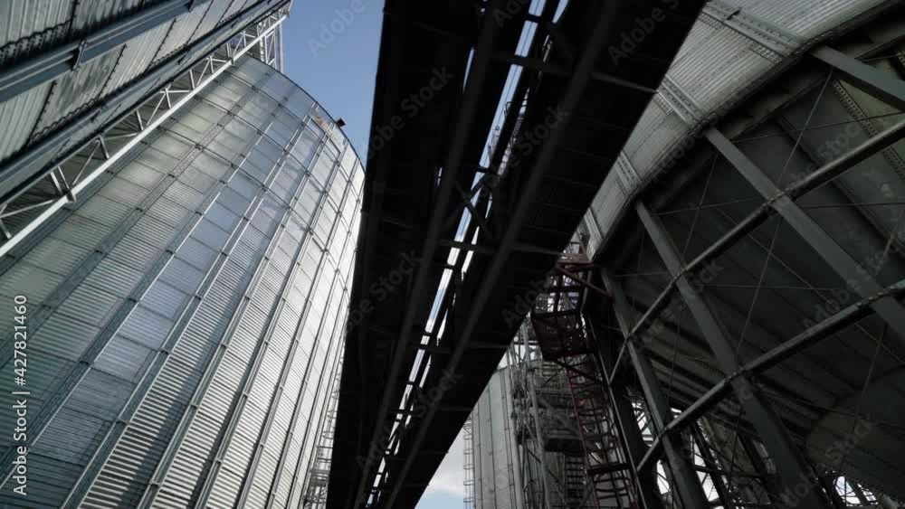 Large metal silo for storing grain. Modern industrial plant. Granary ...