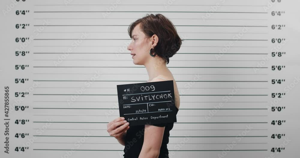 Video „Mugshot of arrested young woman with short haircut turning head ...