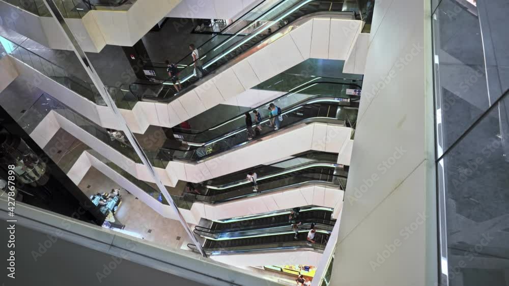 Lots of escalators in the modern multi-level shopping mall center ...