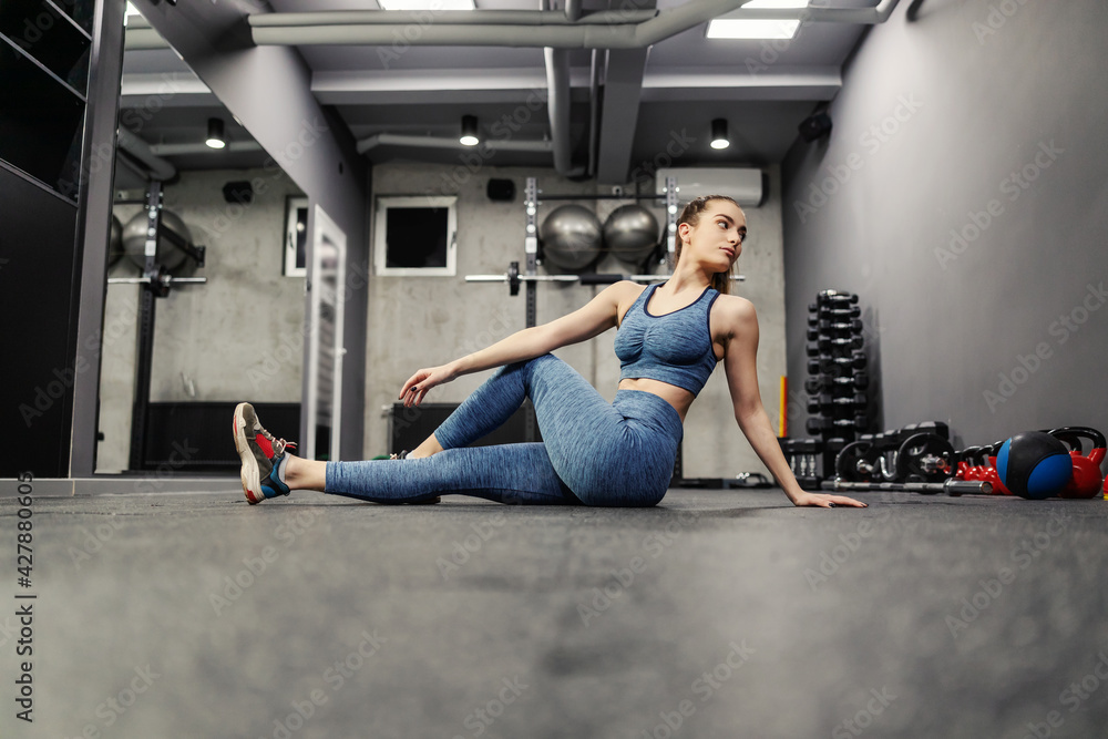 Foto de Stretching the leg muscles. Fit woman in sportswear and good ...