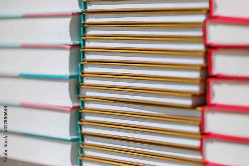 Many identical books are stacked on top of each other in the glass ...