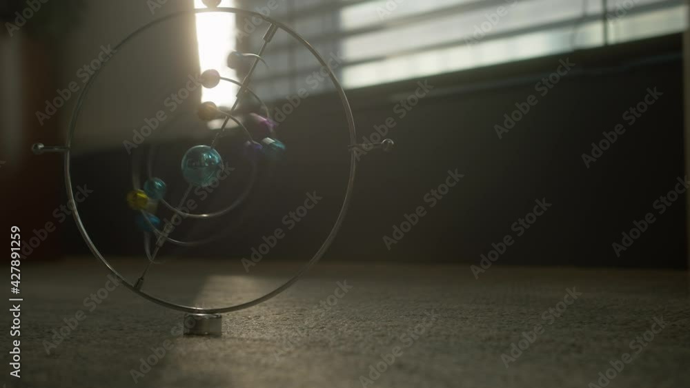 concentric rotating rings around a moving sphere. It looks like a ...