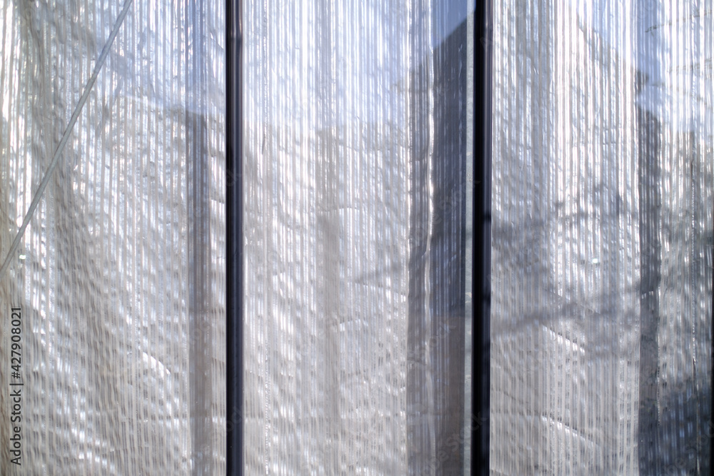 metallic striped thermal isolation curtain behind glass Stock Photo ...