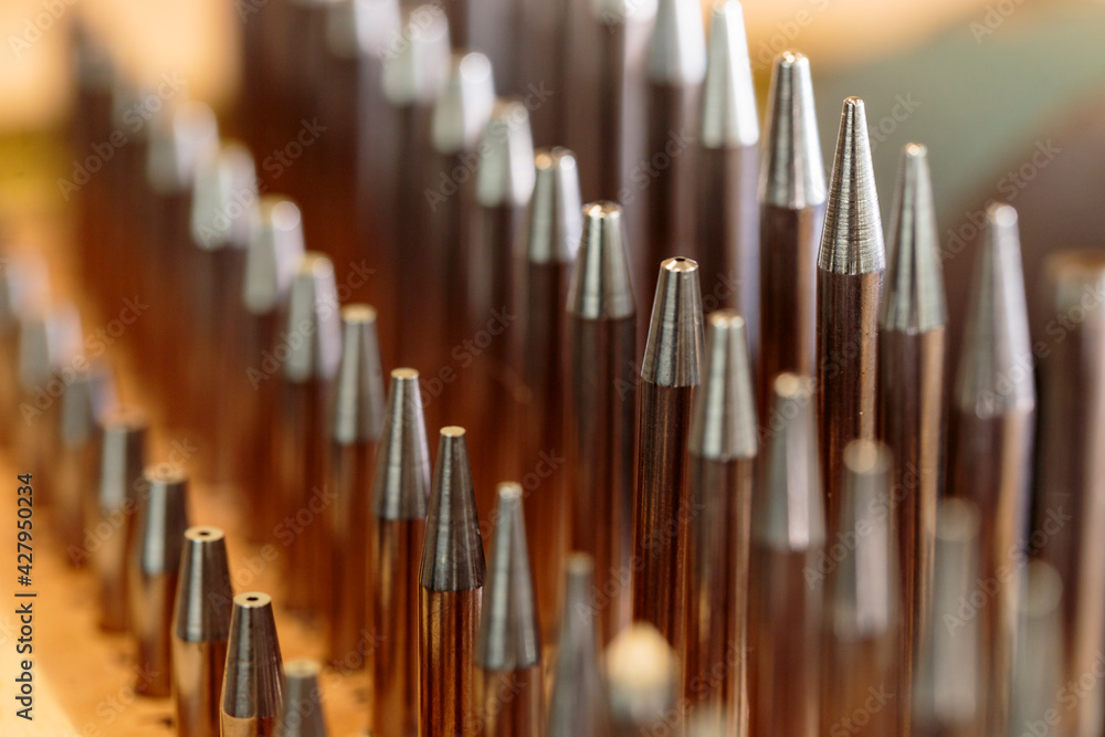 Horizontal closeup view of set of high quality watchmaker staking ...