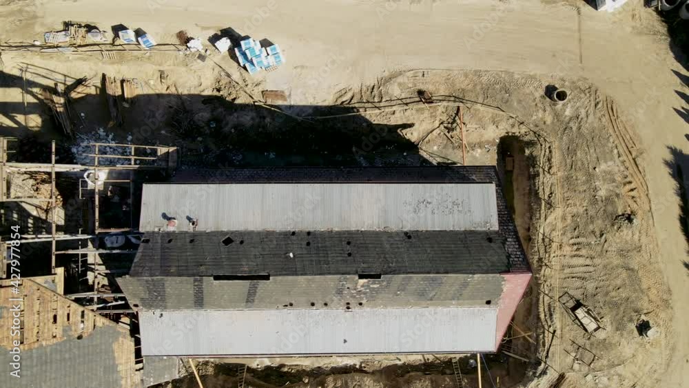 top down demolition of historic roof before restoration, aerial shot ...