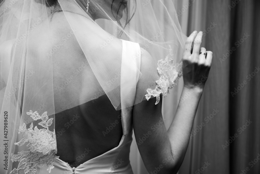 colorless photo. The bride prepares for the wedding and puts on the ...