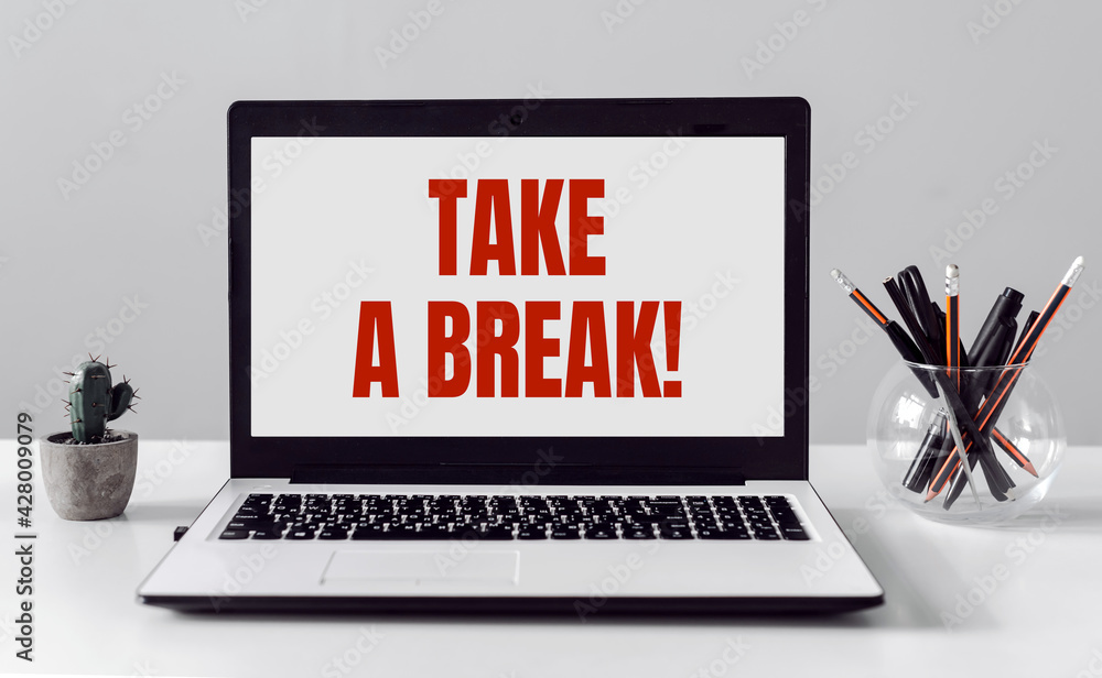 Laptop with TAKE A BREAK! text on modern office background. Stock Photo ...