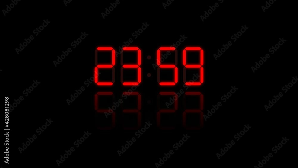 A beautiful red glowing dial of an electronic clock shows the midnight ...