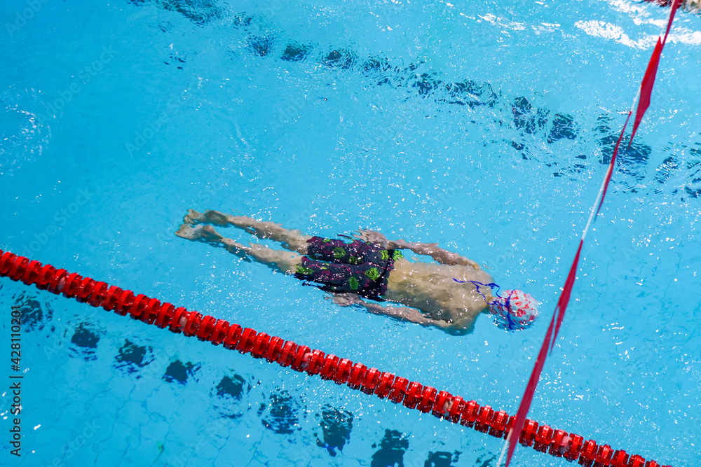 swimmer in the pool, a person swims in the water column, top view, deep ...