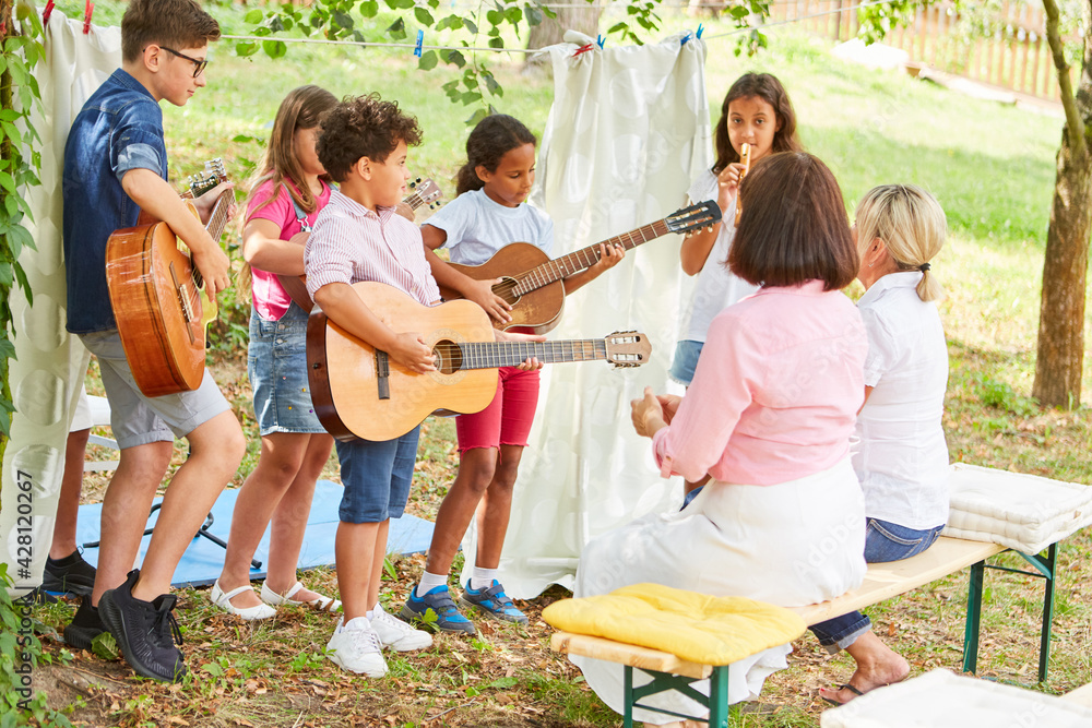 Group of children with guitars at talent show performance Stock Photo ...