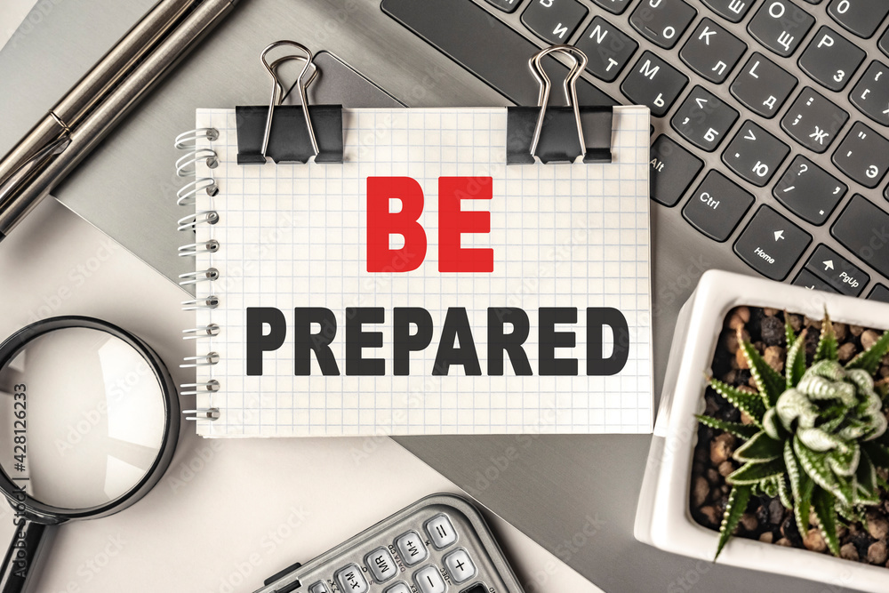 BE PREPARED text on a notepad and laptop, office tools. Business ...