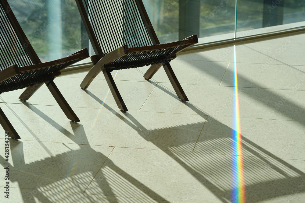 Dispersing sunlight from the glass splitting into a spectrum on a floor ...