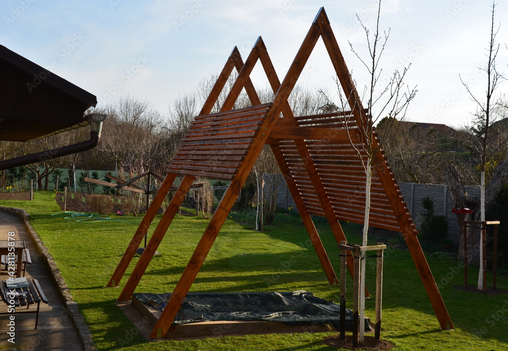 construction of a pergola shading the kindergarten playground with a ...