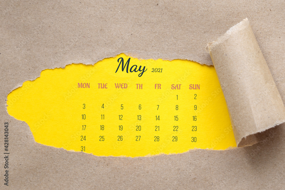 May 2021. Full-month calendar page. Hole in the paper with the edges ...