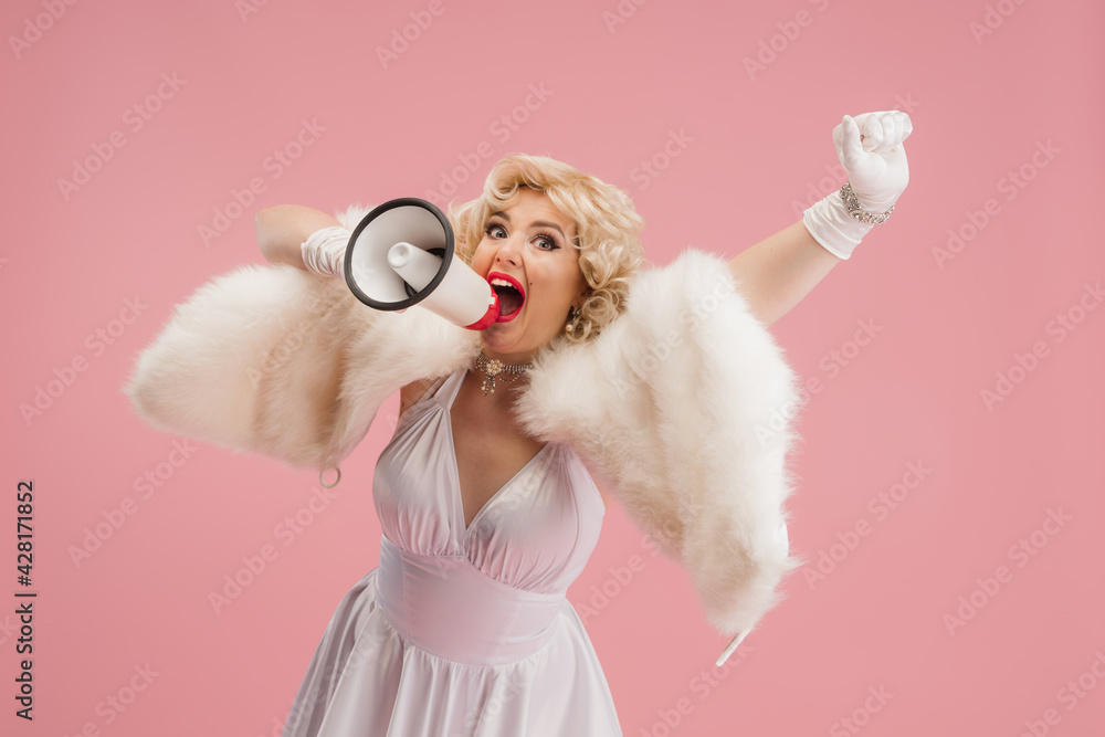 Portrait of young woman in white dress on coral pink background. Female ...