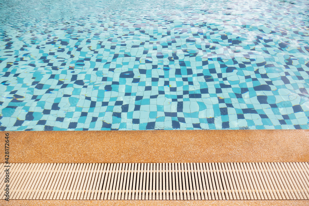 Close up with copy space of beautiful swimming pool with rock rim and ...