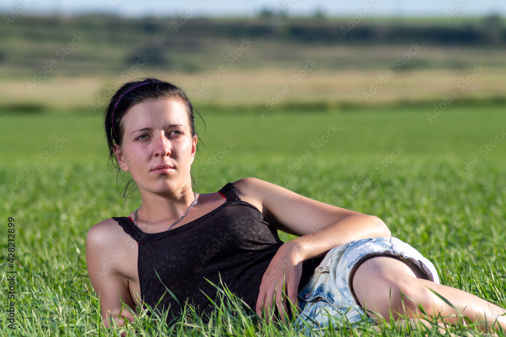 Beautiful girl lying on the lawn Stock Photo | Adobe Stock