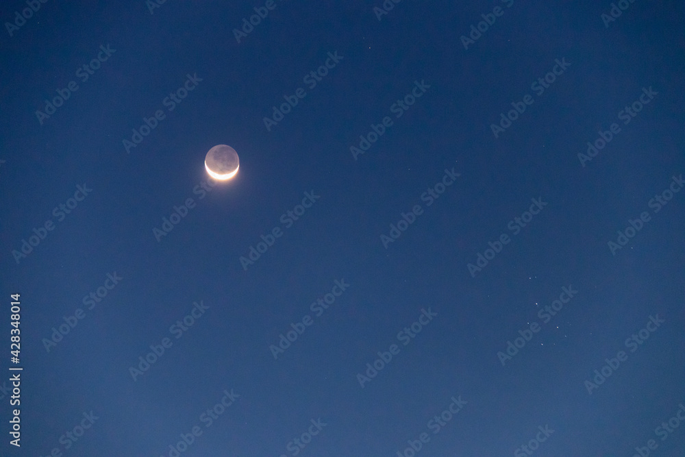 Crescent moon with earthshine is a soft, faint glow on the dark side of ...