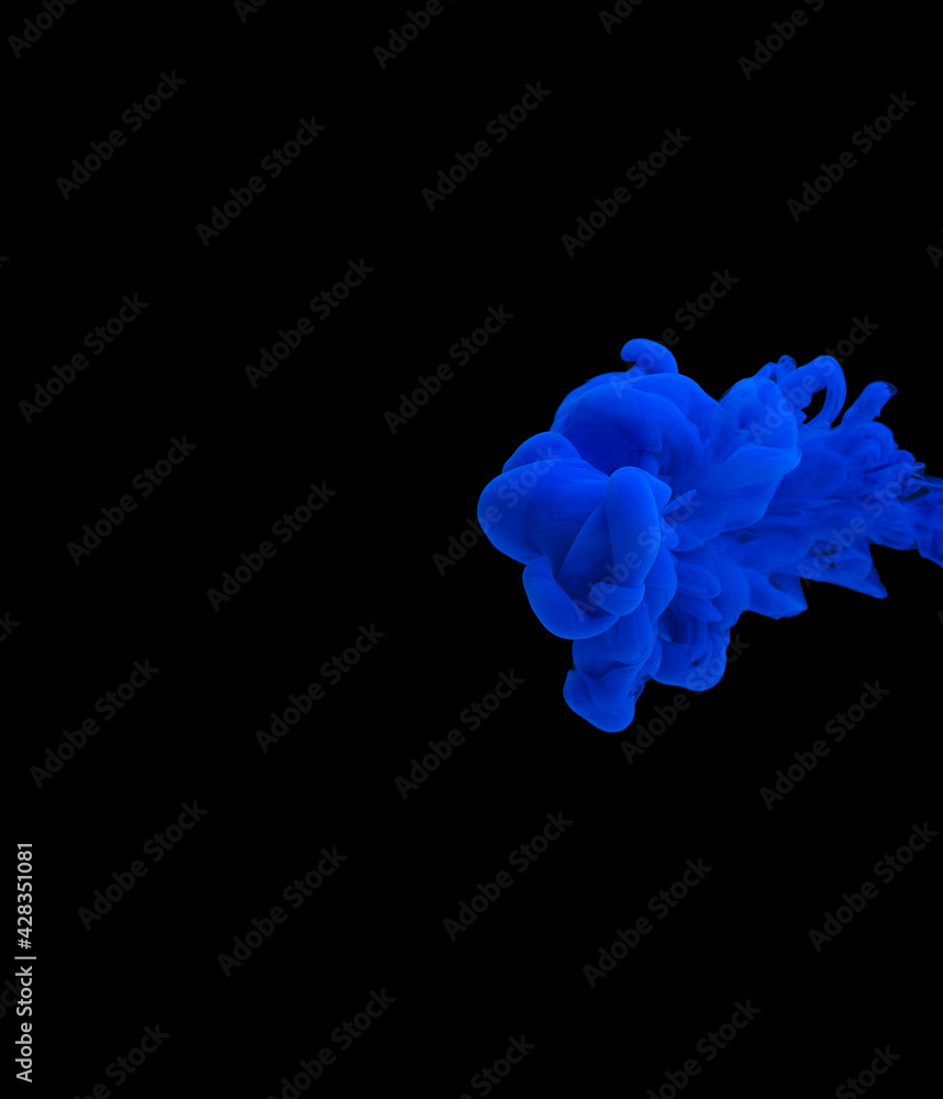 explosion of acrylic blue paint in water with bubbles. Black background ...