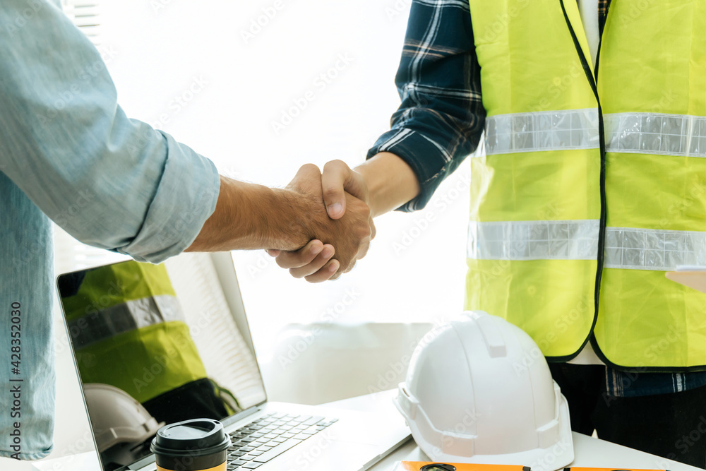 engineer, architect, construction worker team hands shaking after plan ...