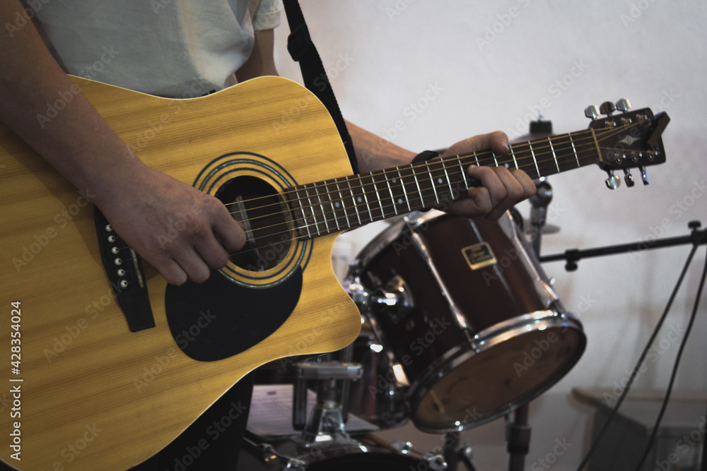 Yellow acoustic guitar close up playing music on musical instruments ...