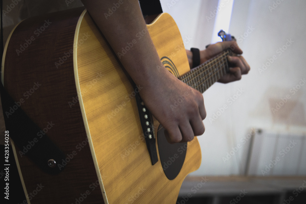 Yellow acoustic guitar close up playing music on musical instruments ...