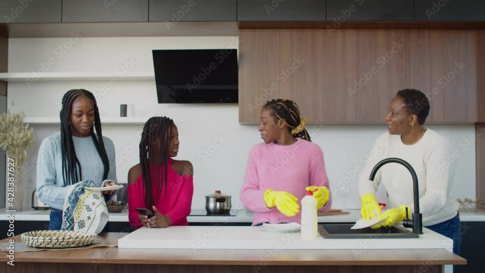 Positive attractive african family doing household chores in domestic ...