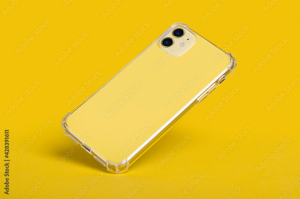 Yellow iPhone 11 in clear silicone case falls down isolated on yellow ...