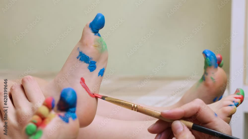 Art therapy. Funny feet kids with bright colored toes close up. Child ...