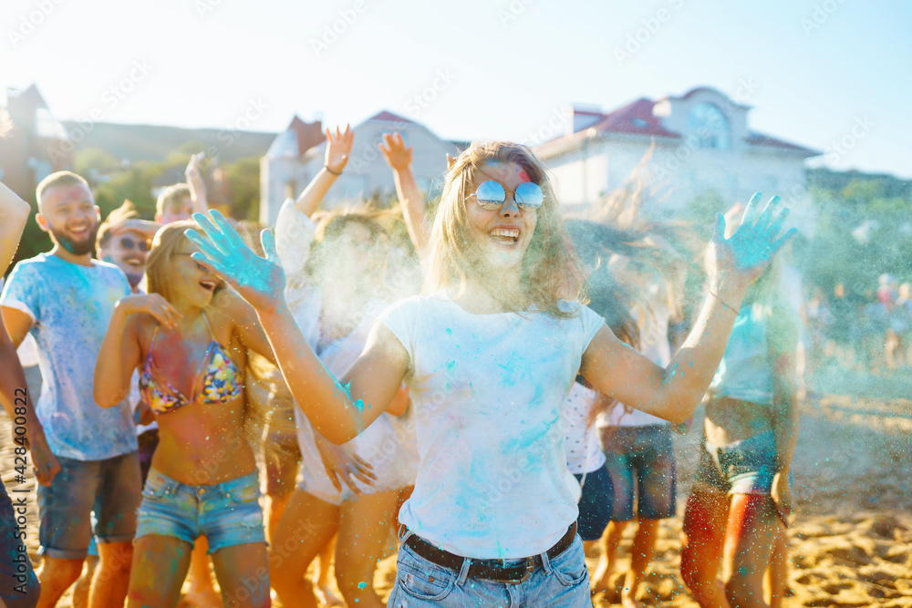Group of people have fun at the holi festival of colors. Smiling faces ...