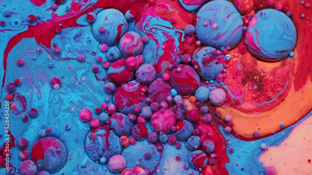 Abstract background motion with blue and red ink bubbles overflowing ...