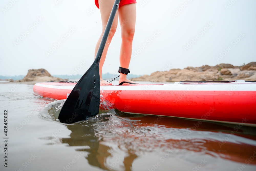 Stand up paddleboarding women paddle on the beach Happily on a ...
