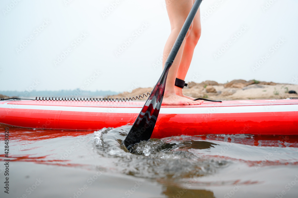 Stand up paddleboarding women paddle on the beach Happily on a ...