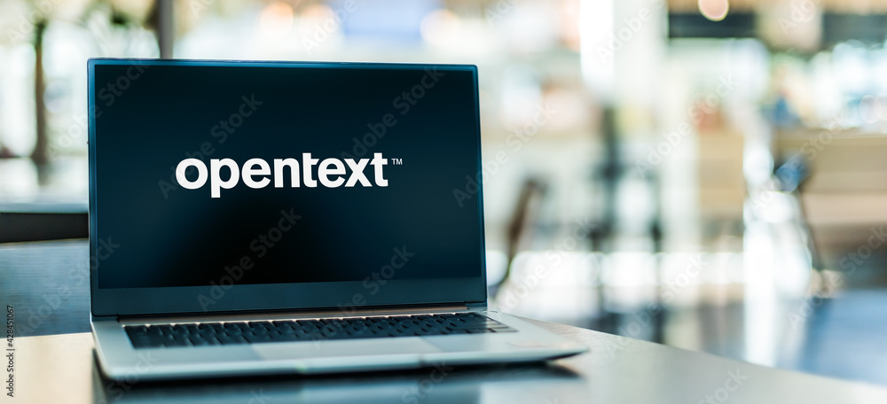 Laptop computer displaying logo of OpenText Stock Photo | Adobe Stock