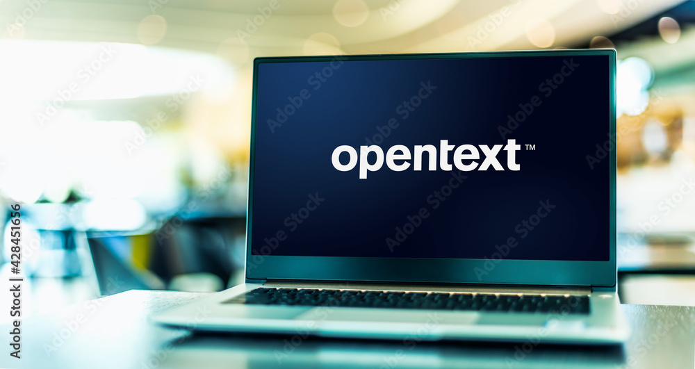 Laptop computer displaying logo of OpenText Stock Photo | Adobe Stock